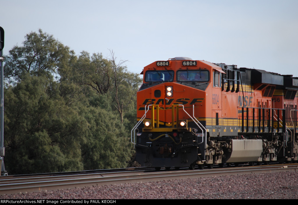 BNSF 6804 showing the wear and tare off the Transcon heads west towards BNSF Barstow and a crew ...